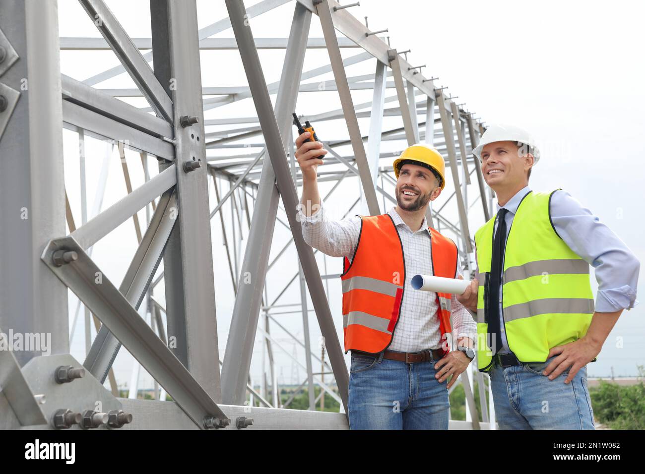 Professional engineers working on installation of electrical substation ...