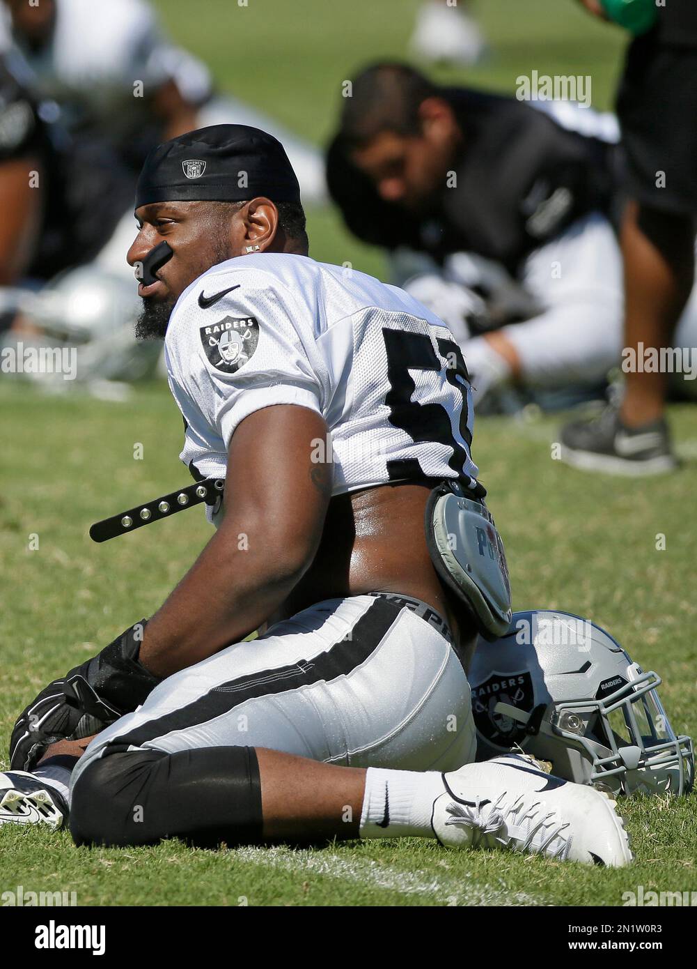 Oakland Raiders outside linebacker Sio Moore smiles while stretching ...