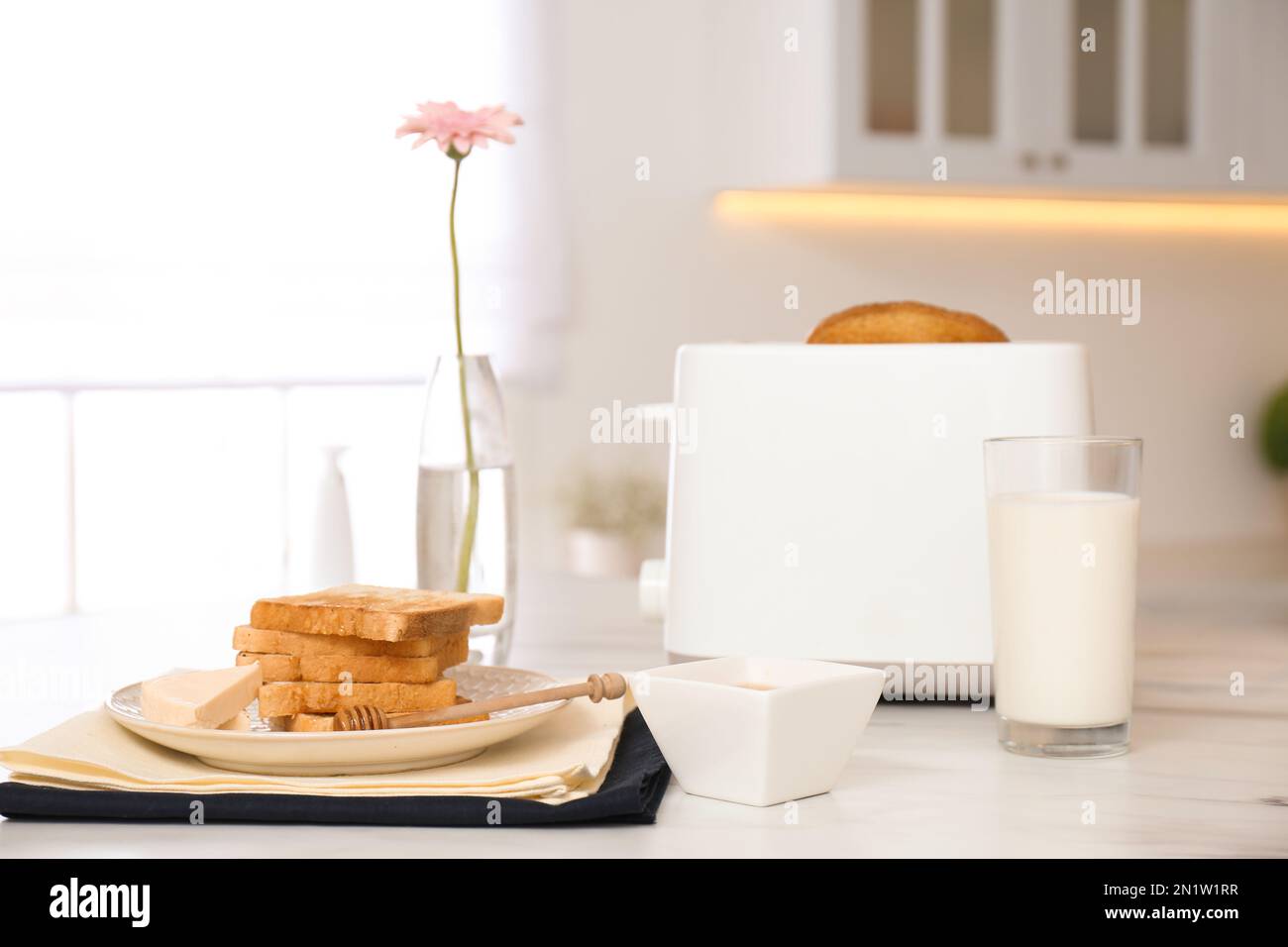 Modern toaster and tasty breakfast on white marble table in kitchen Stock Photo - Alamy