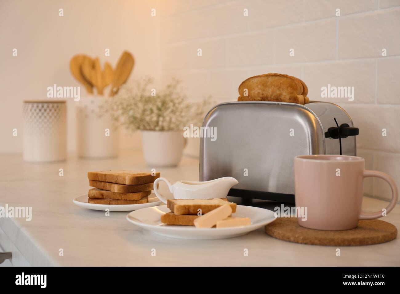 Modern toaster and tasty breakfast on counter in kitchen Stock Photo ...