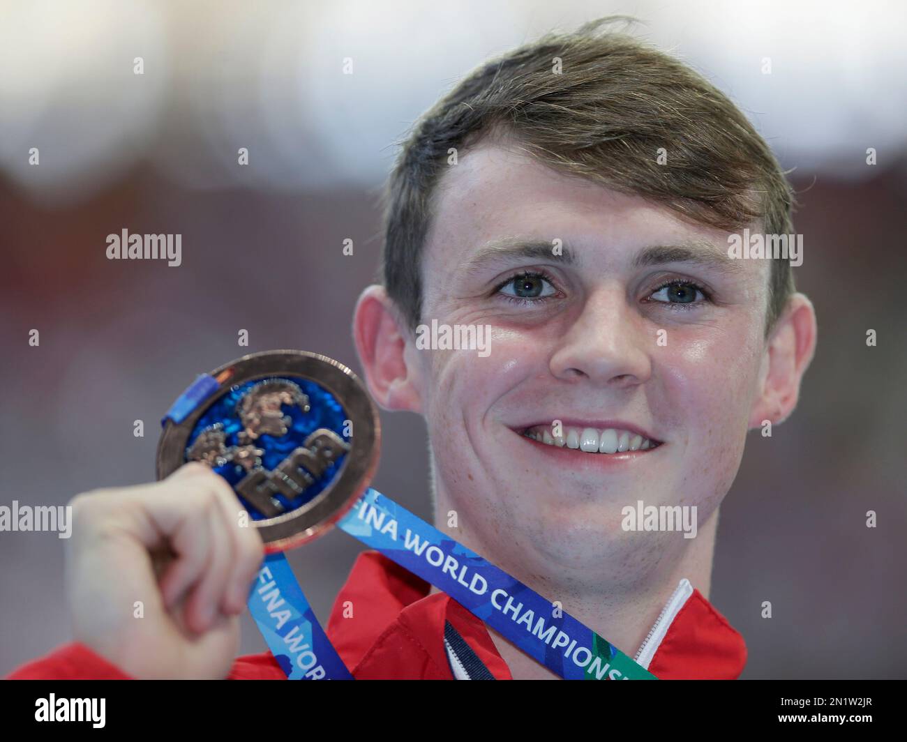 Britain's Ross Murdoch holds his bronze medal following his third place ...