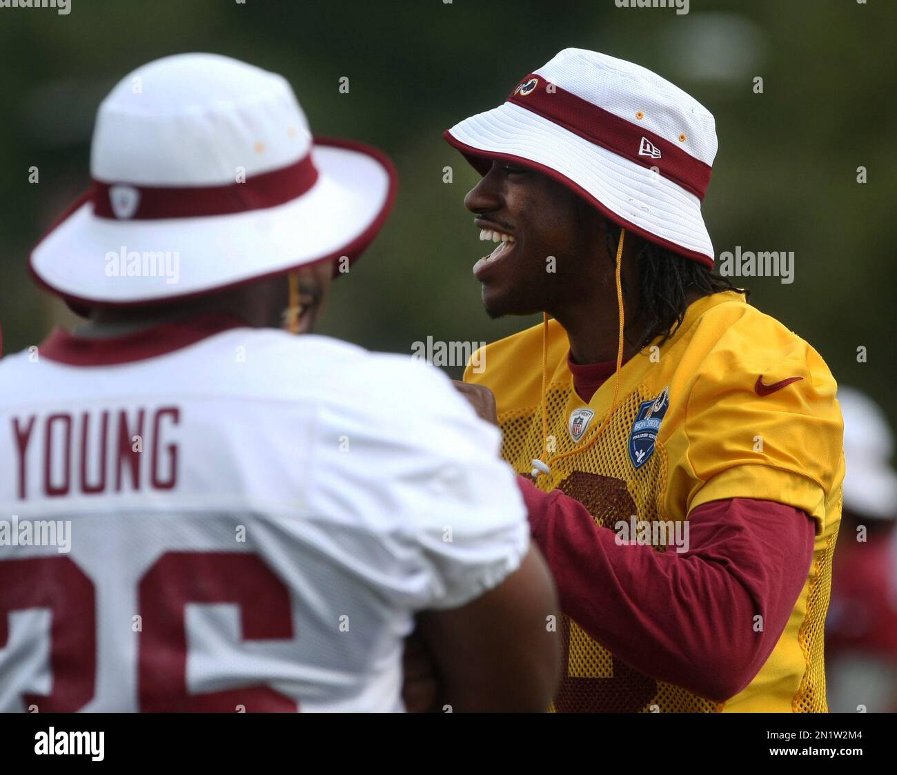 Washington Redskins quarterback Robert Griffin III, right, laughs with ...