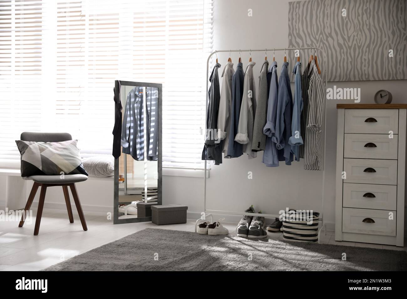 Dressing room interior with clothing rack and mirror Stock Photo - Alamy