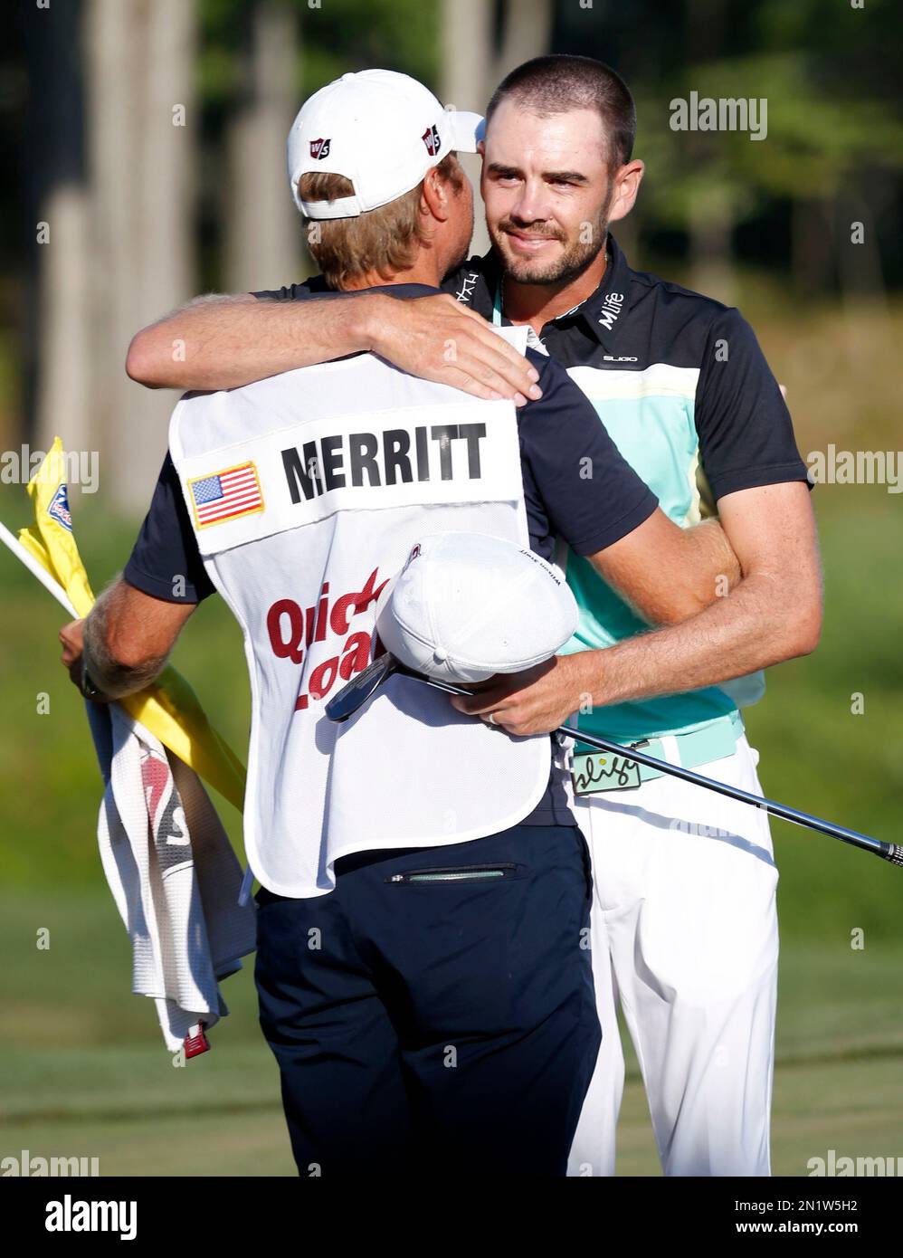Troy Merritt hugs his caddie as he celebrates winning the Quicken Loans ...