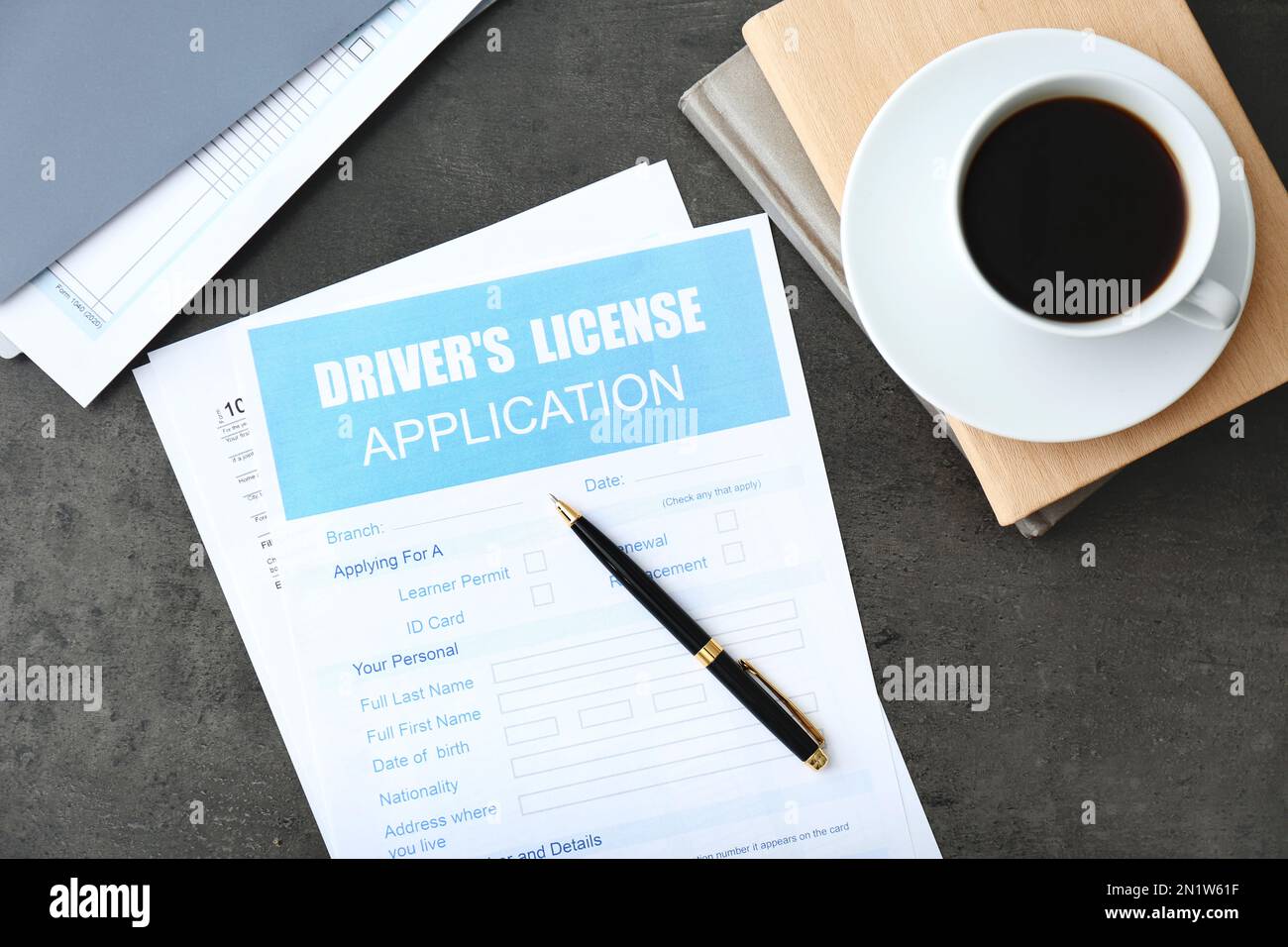 Driver's license application form, stationery and cup of coffee on grey table, flat lay Stock ...