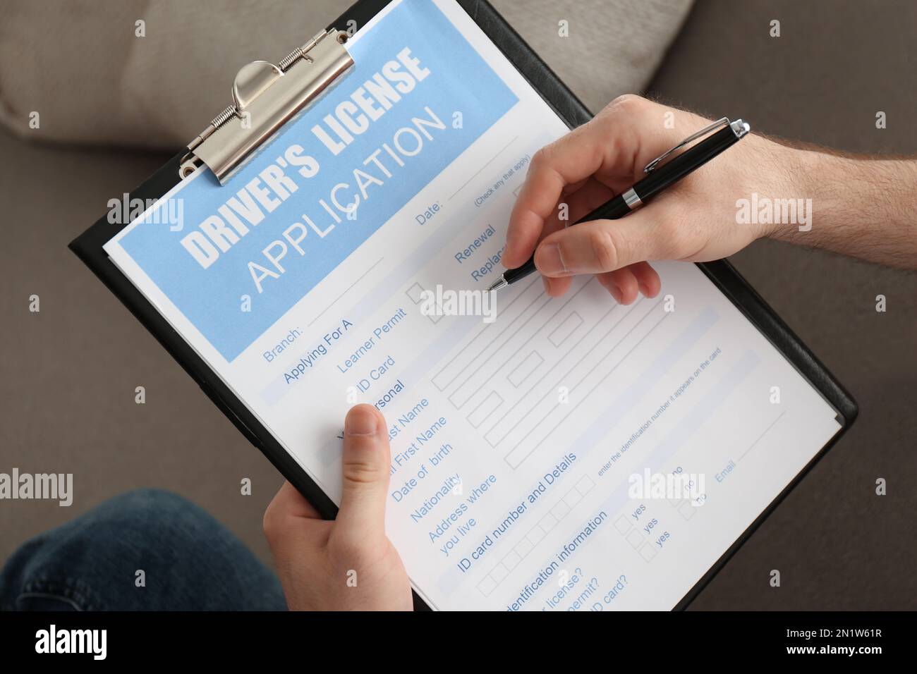 Man filling in driver's license application form, closeup Stock Photo - Alamy