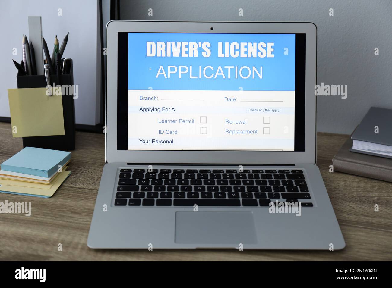 Laptop with driver's license application form on table in office Stock Photo - Alamy