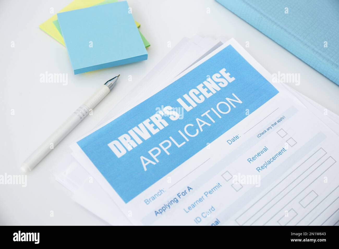 Driver's license application form and stationery on white table Stock Photo - Alamy