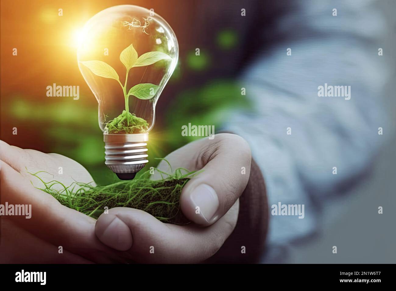 Man hand grasping a light bulb and sprout of a plant inside ...