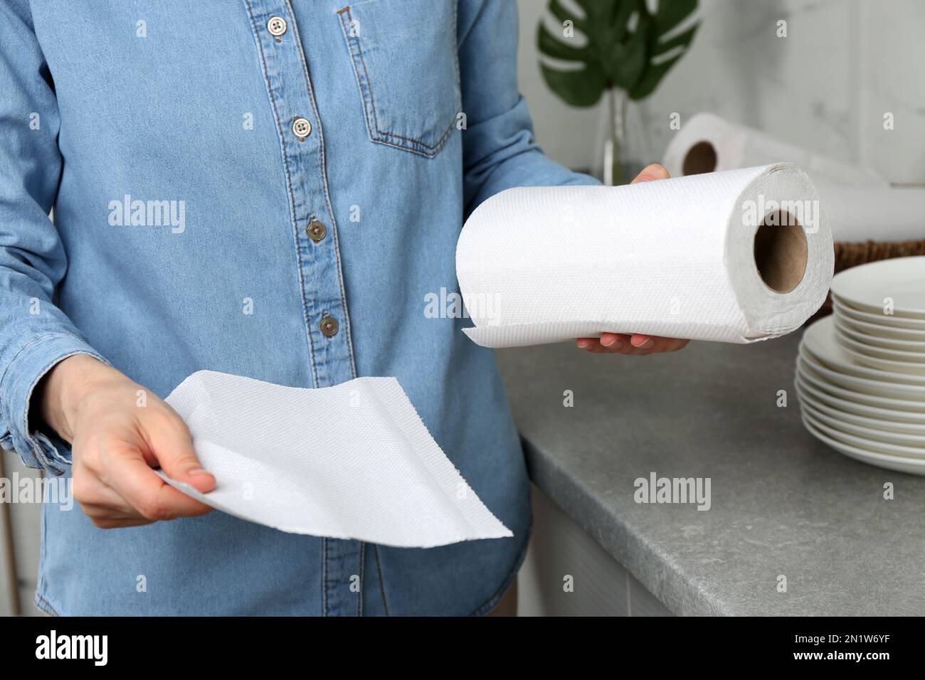 Woman using paper towels in kitchen, closeup Stock Photo - Alamy