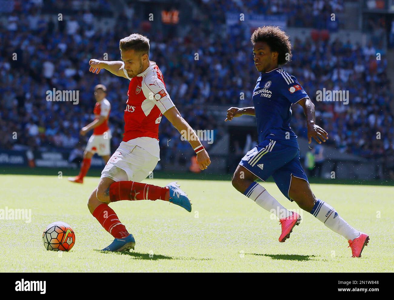 Arsenal's Aaron Ramsey, left, tries a shot on goal ahead of Chelsea's ...