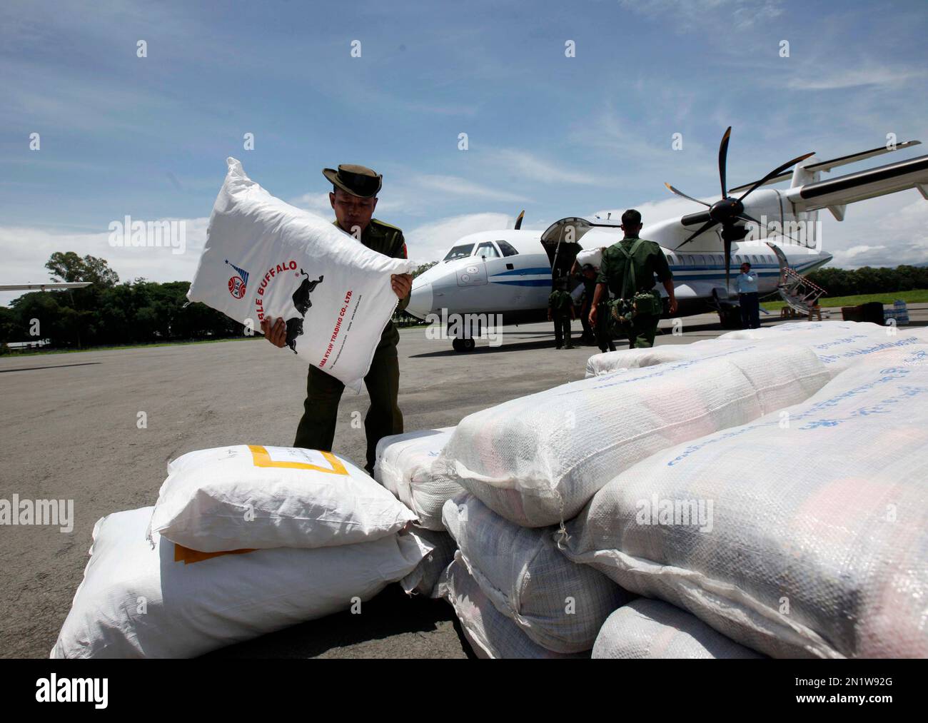 Myanmar soldiers unload relief items from a plane at Kalay airport in ...