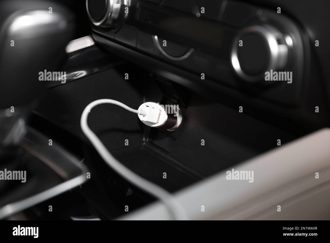 Charging cable connected to plug in car Stock Photo - Alamy