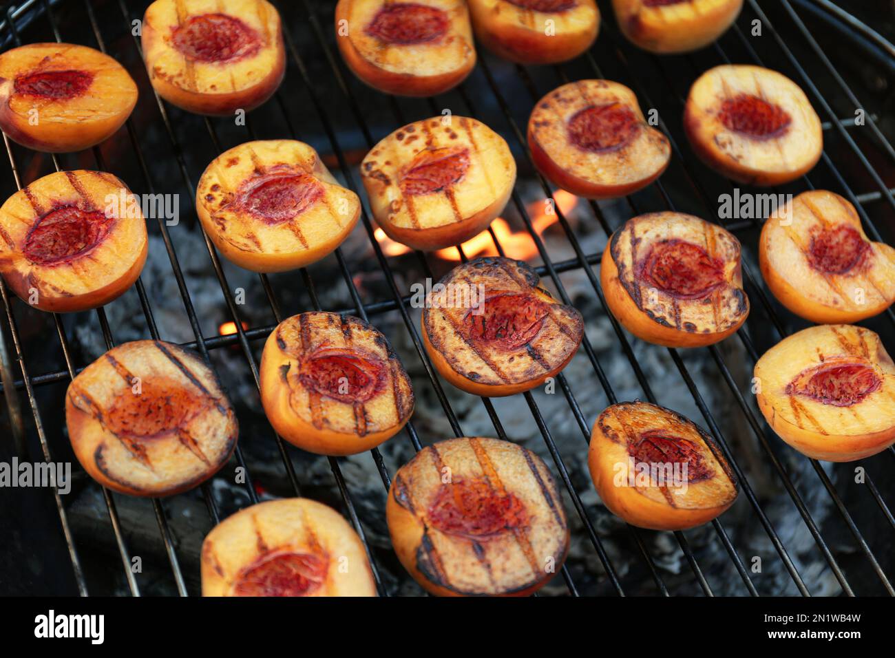 Modern grill with tasty cut peaches, closeup Stock Photo - Alamy