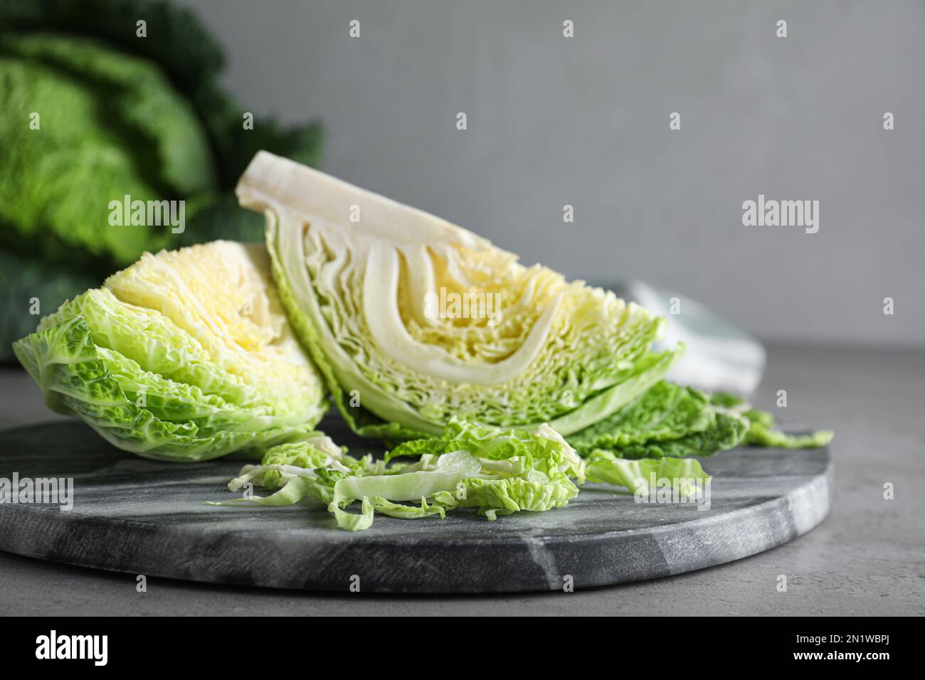Cut fresh savoy cabbage on grey table, closeup Stock Photo - Alamy
