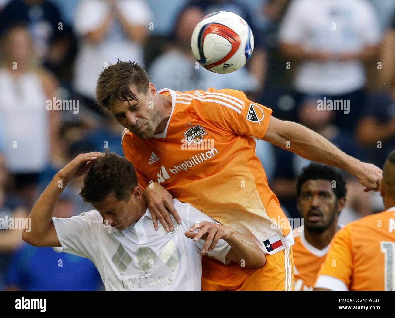 Houston Dynamo defender David Horst, top, heads the ball over Sporting ...