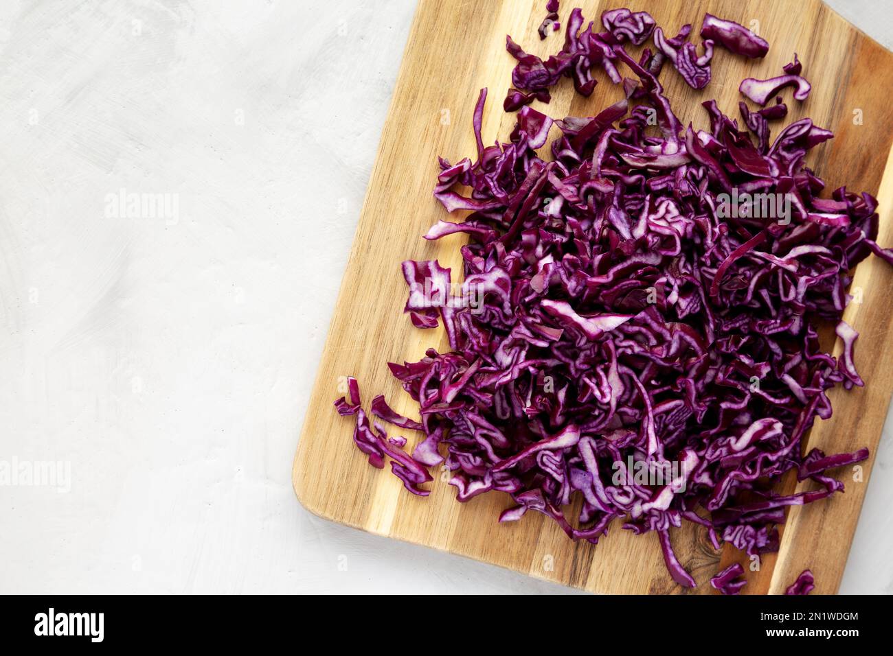 Shredded Purple Cabbage on a Board, top view. Flat lay, overhead, from ...