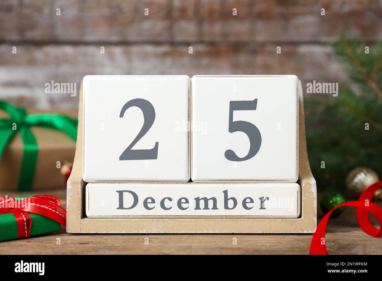 Wooden block calendar and Christmas decor on table. Holiday celebration ...