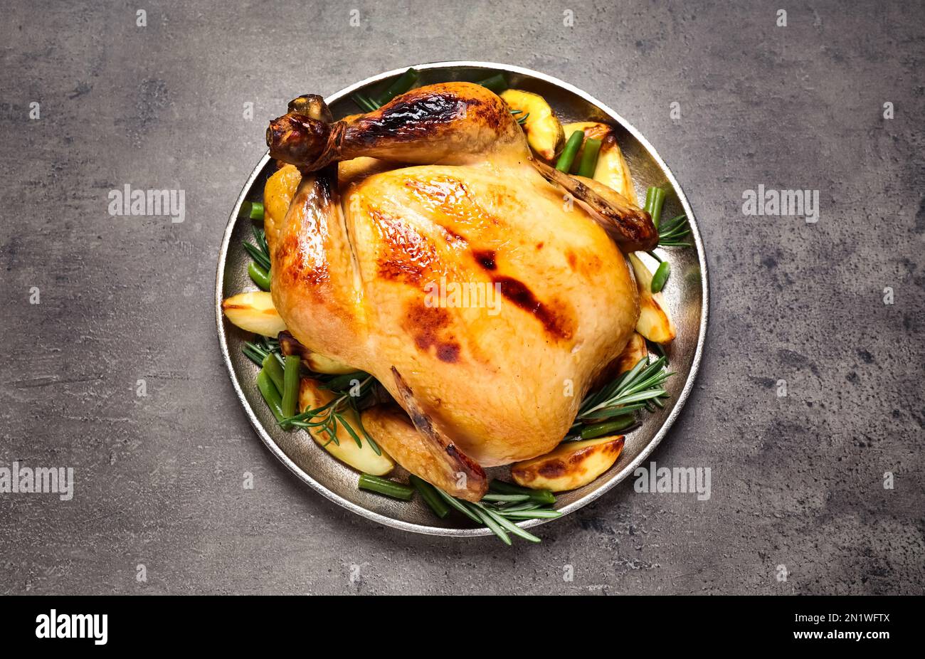 Delicious cooked turkey with garnish on grey table, top view ...