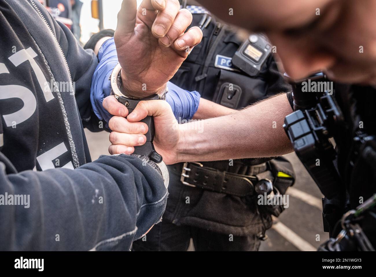 man handcuffed close up by police. Police arrest. detail shot of hands ...