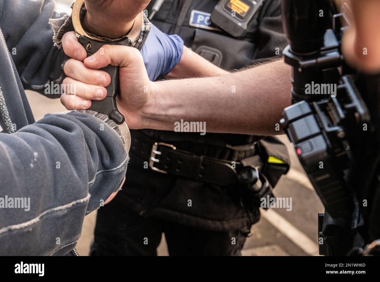 man handcuffed close up by police. Police arrest. detail shot of hands ...