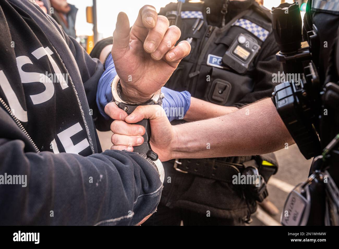 man handcuffed close up by police. Police arrest. detail shot of hands ...