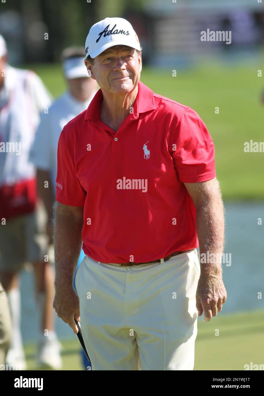 Tom Watson walks off the course on the 18th hole during the first round ...