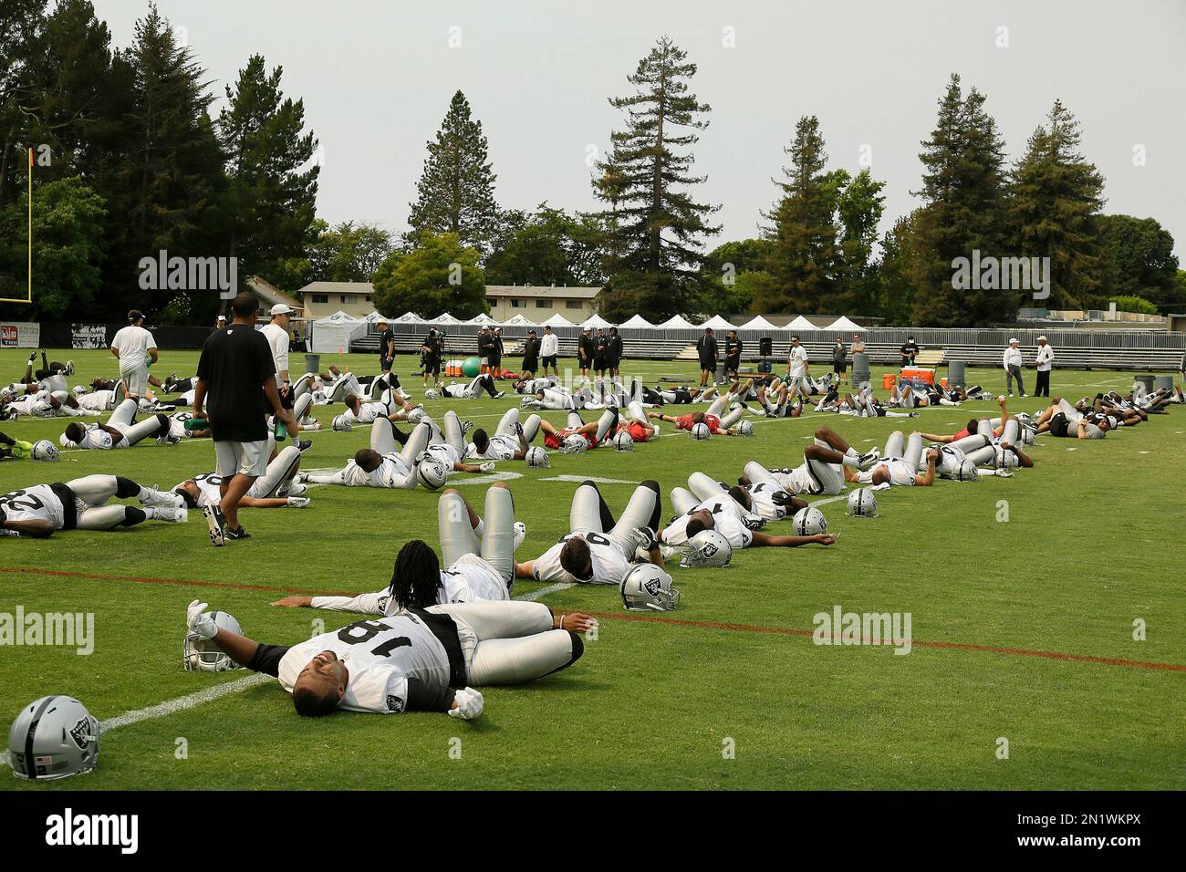 The Oakland Raiders go through stretching exercises during NFL football ...