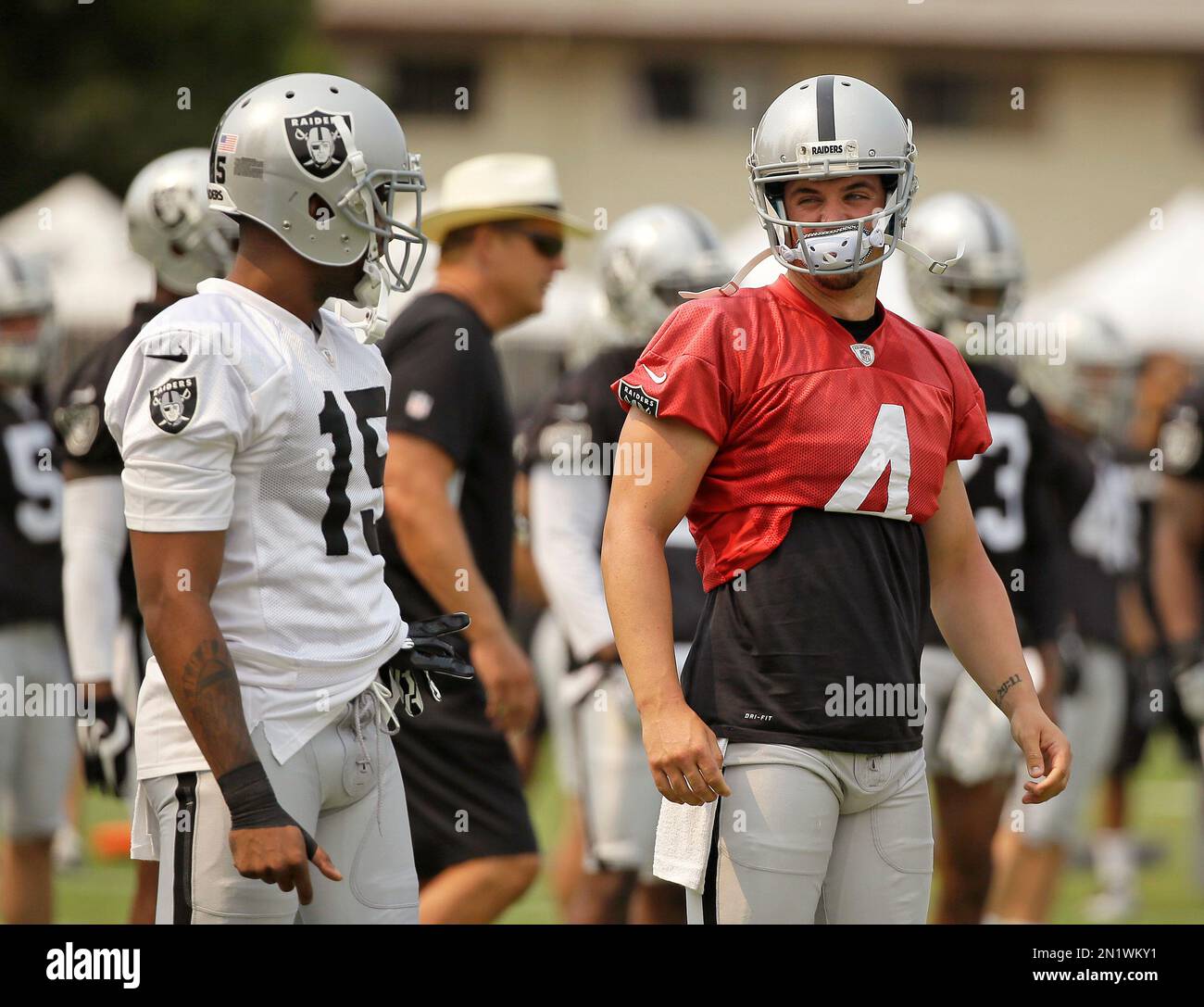 Oakland Raiders quarterback Derek Carr, right, talks with wide receiver ...