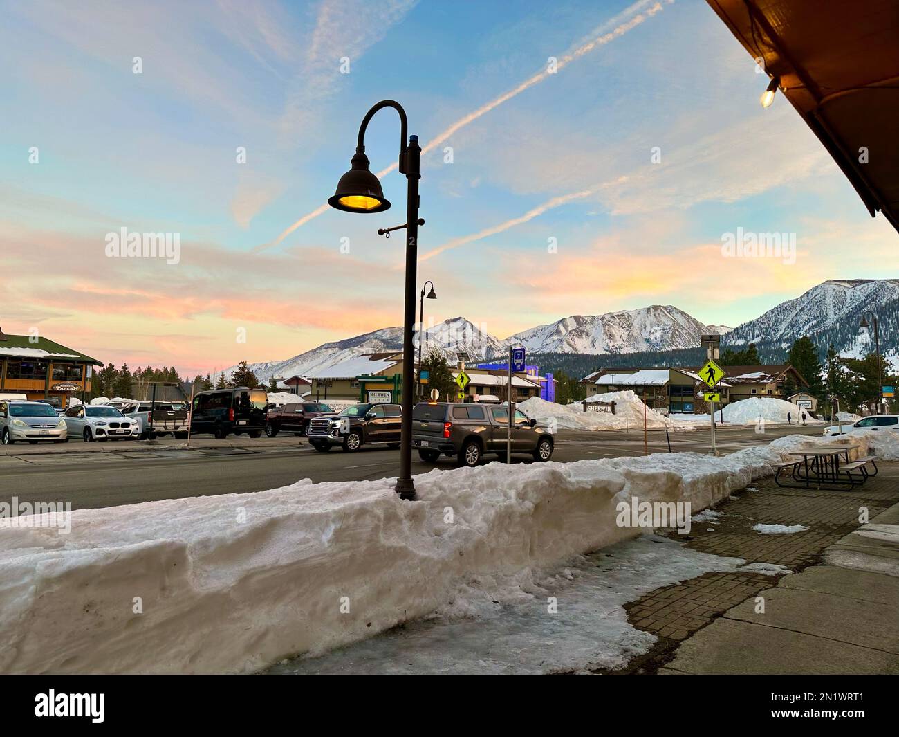 A street lamp on the background of the mesmerizing snowy Mammoth ...