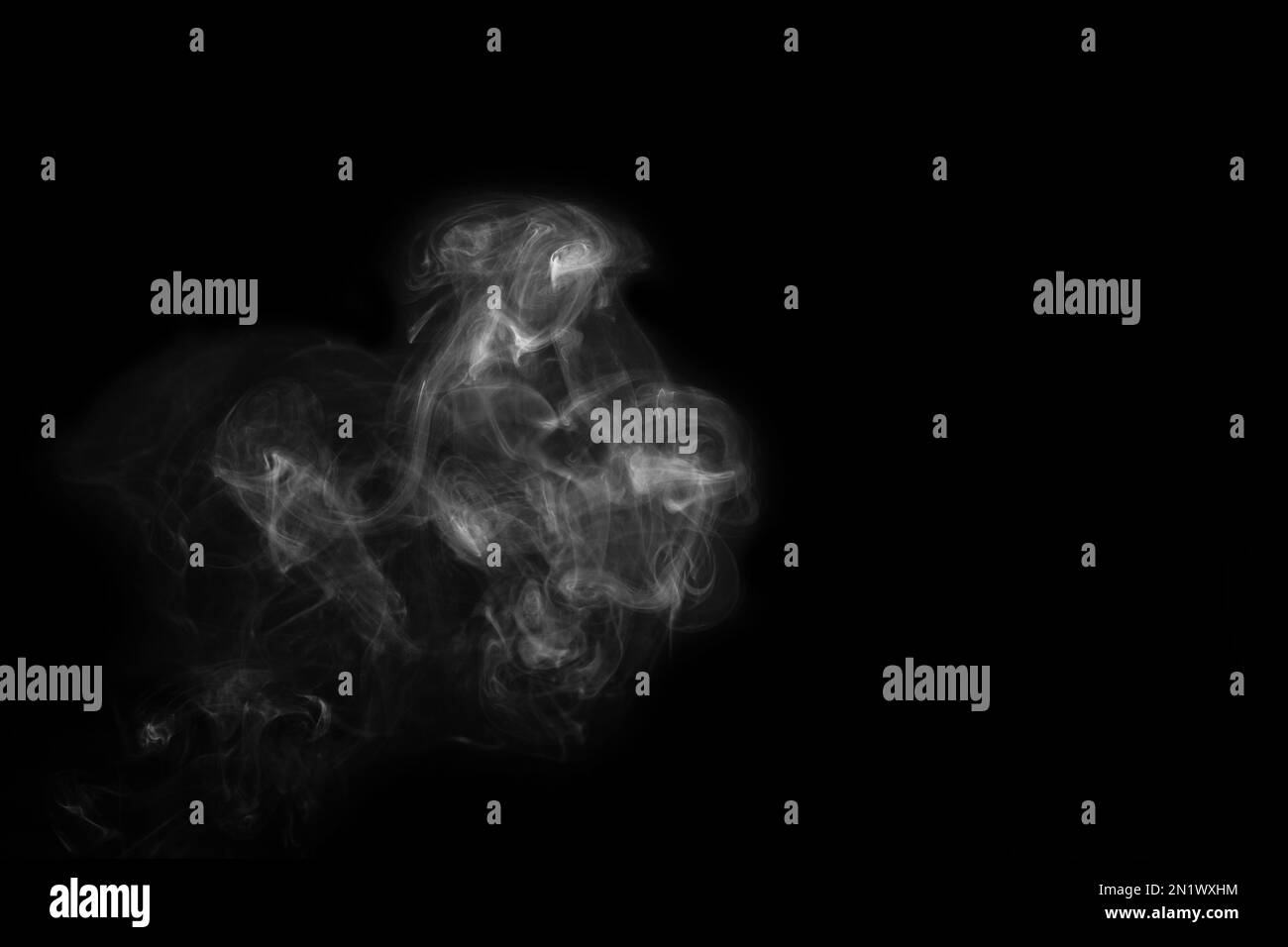 White smoke in the shape of a bird on a black background. stock image ...