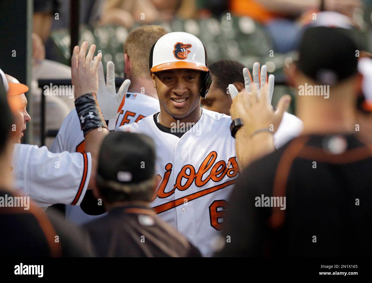 Baltimore Orioles' Jonathan Schoop high-fives teammates in the dugout ...
