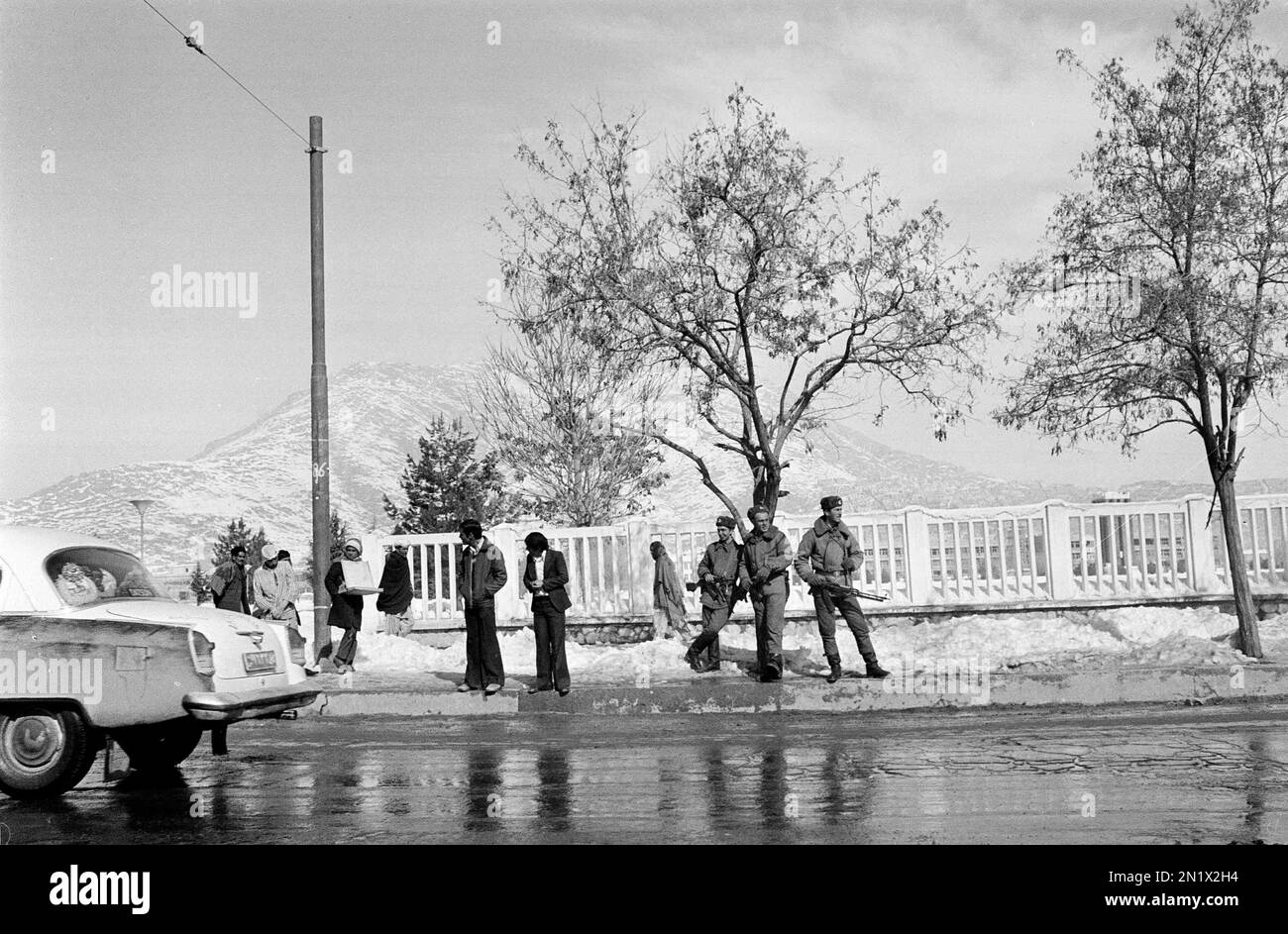 Soviet soldiers take it easy as they patrol a road in suburban Kabul ...