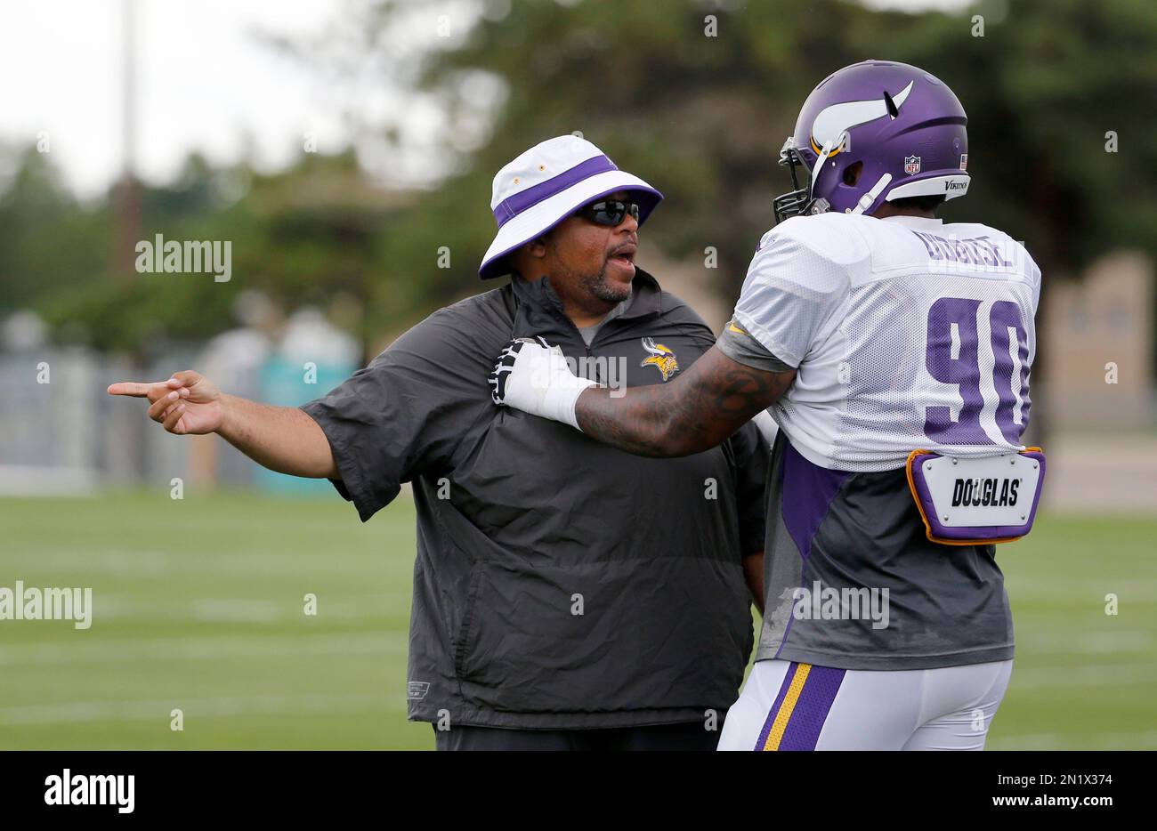 Minnesota Vikings defensive line coach Andre Patterson, left, instructs ...