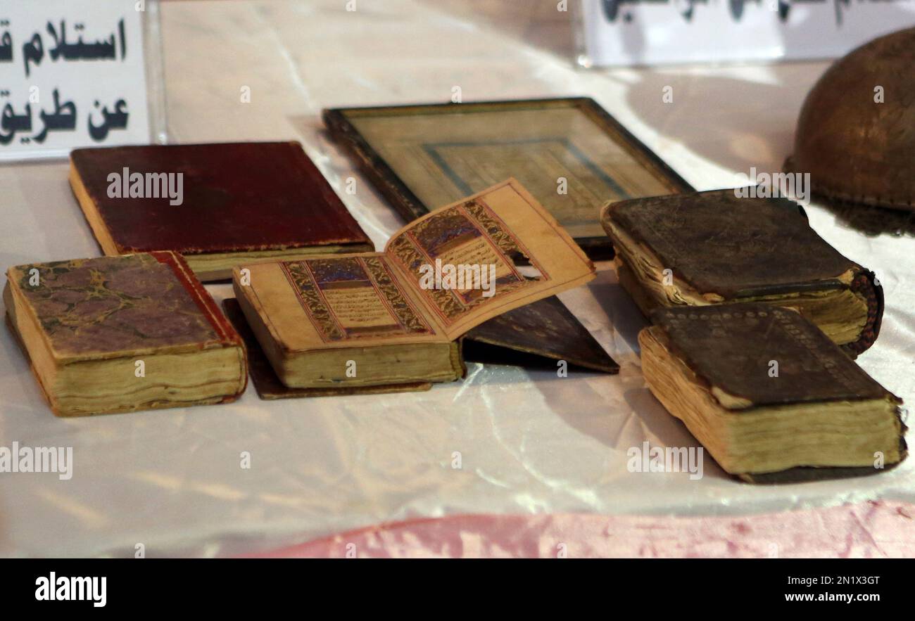 Recovered antique copies of the Quran, Islam's holy book, are displayed ...