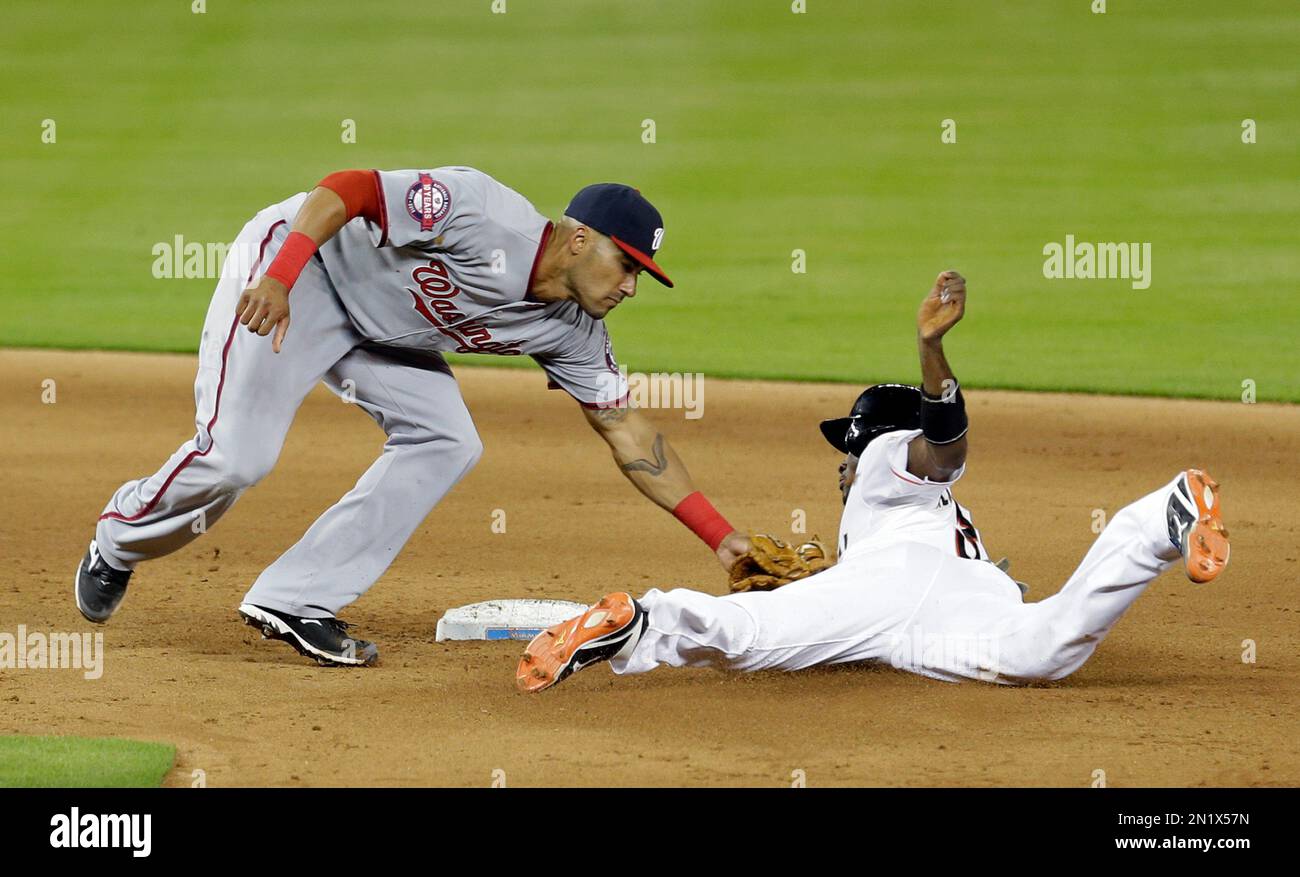 Miami Marlins' Adeiny Hechavarria (3) is tagged out trying to steal ...