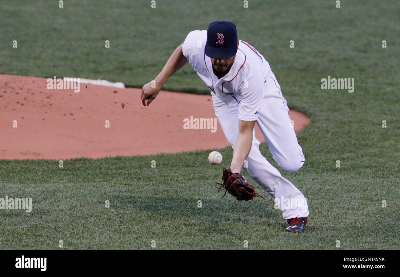 Boston Red Sox starting pitcher Joe Kelly errors while fielding a ...