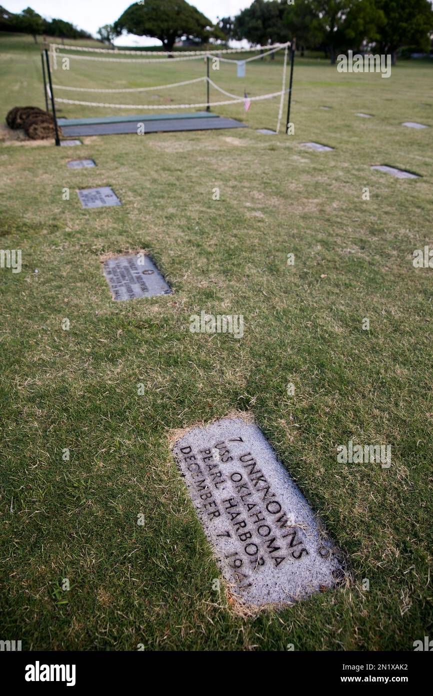 A gravestone with the remains of USS Oklahoma crew members killed in ...