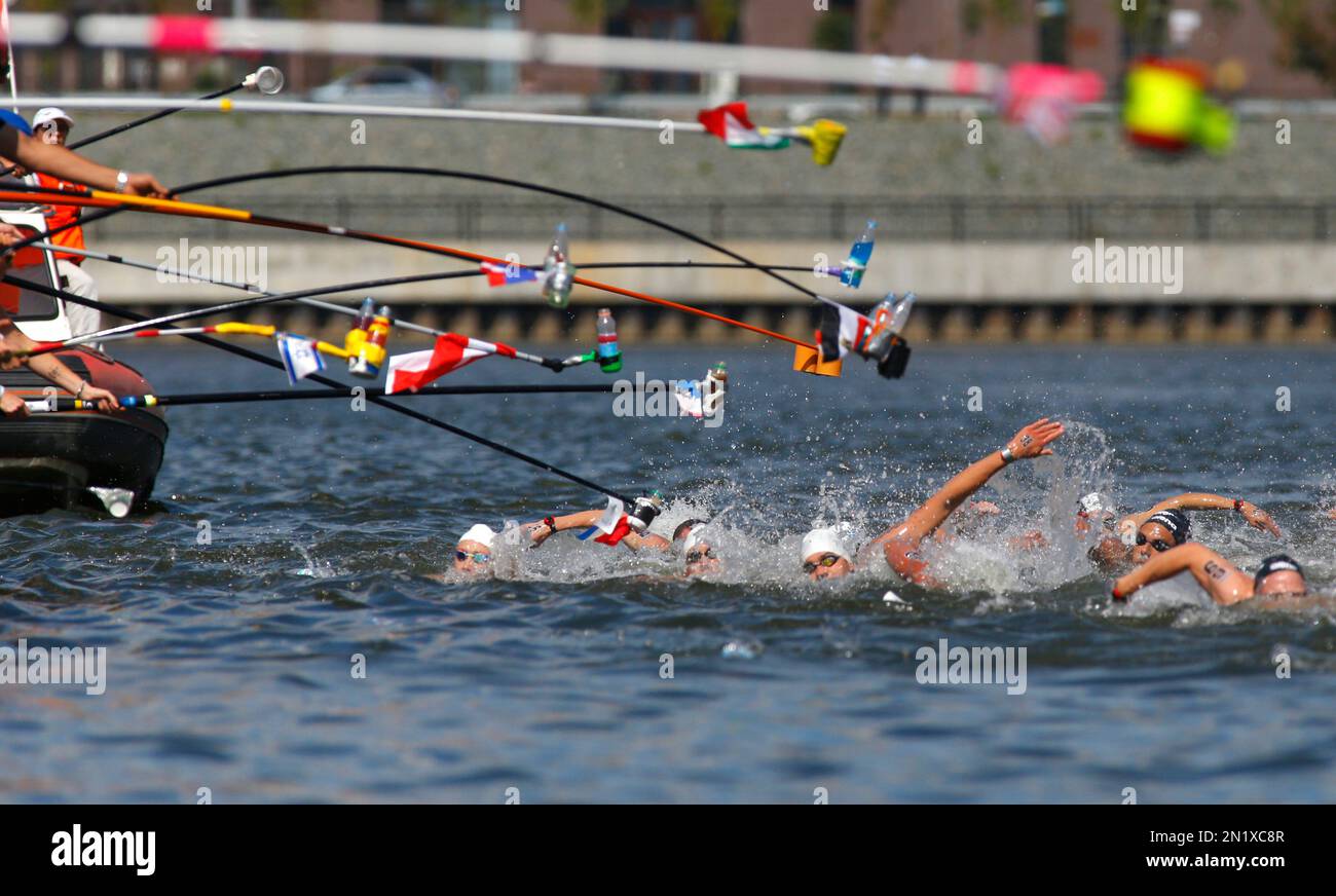 Athletes get nutritional drinks as they compete in the men's 10km open ...