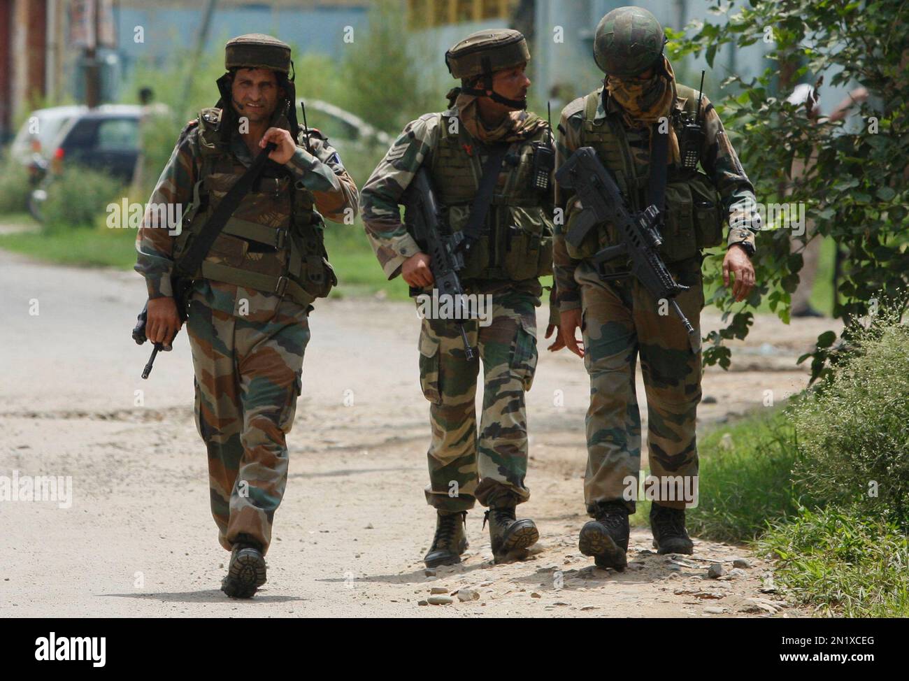 Indian army soldiers walk during a fight in the town of Dinanagar, in ...
