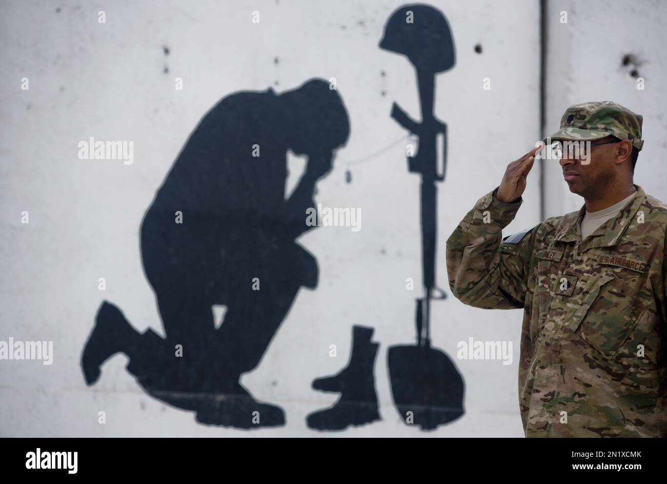 A U.S. member of the air force salutes during a change of command ...