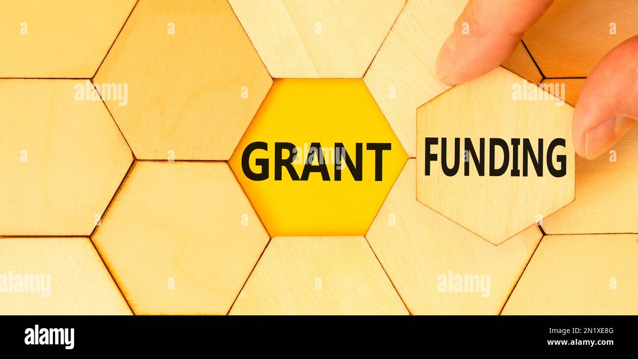 Grant funding symbol. Concept words Grant funding on wooden puzzles ...