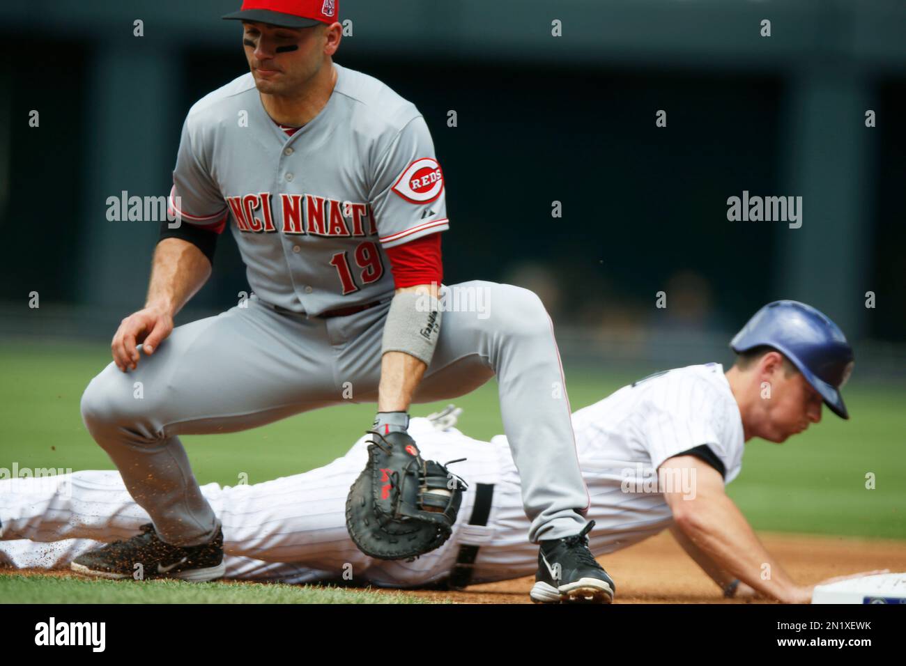 Cincinnati Reds first baseman Joey Votto, front, fields a pickoff ...