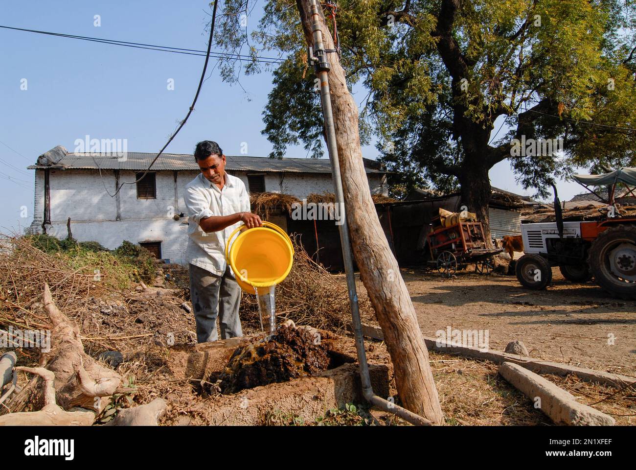 INDIA, Madhya Pradesh, Kasrawad, small biogas plant on farm for cooking ...