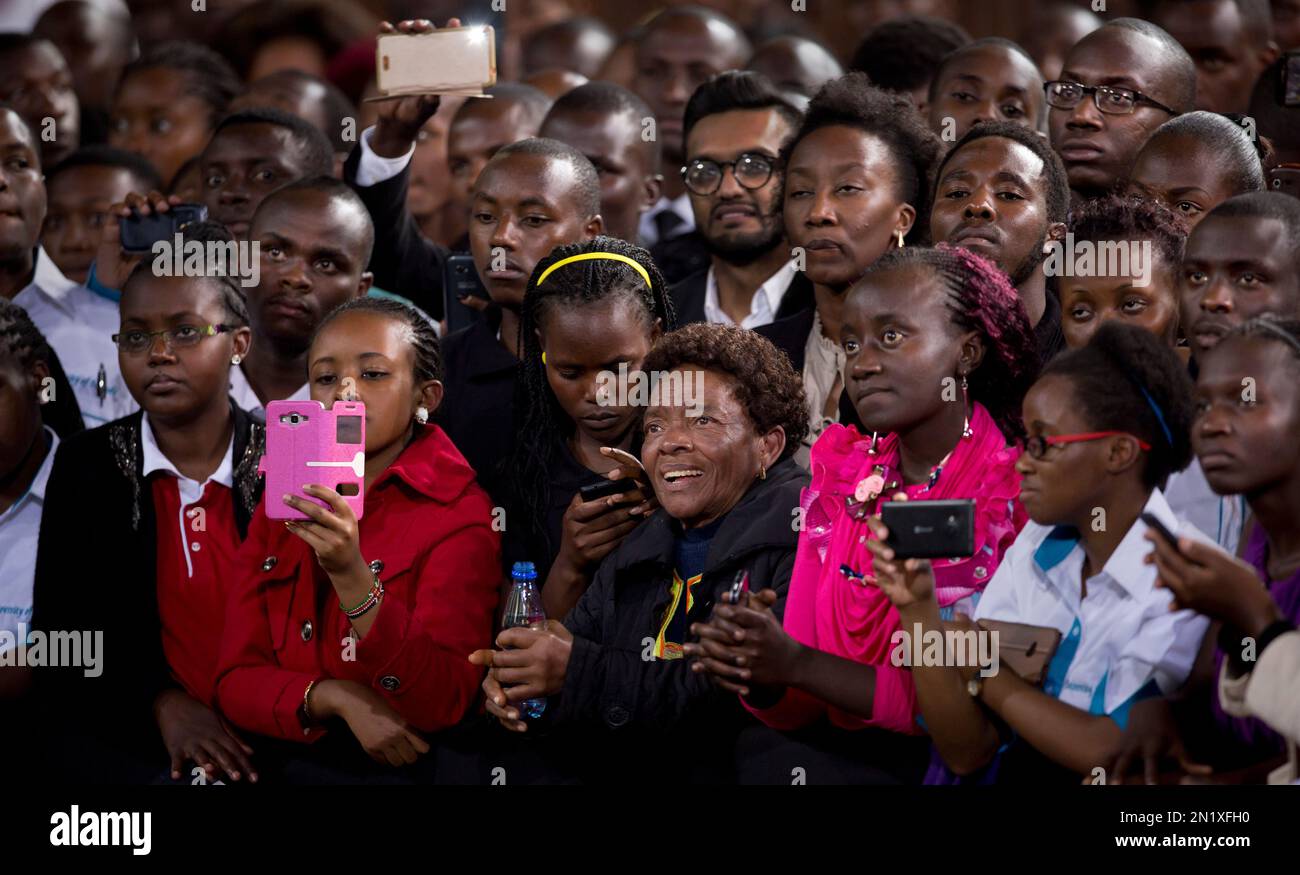 Members of the audience at the front of the crowd listen to President ...