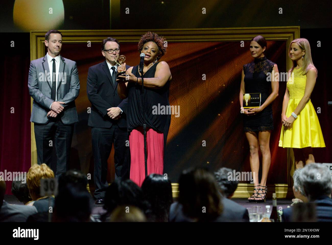 Jim Deeken, from left, Lorenzo Benet and Janet Dotson accept the award ...