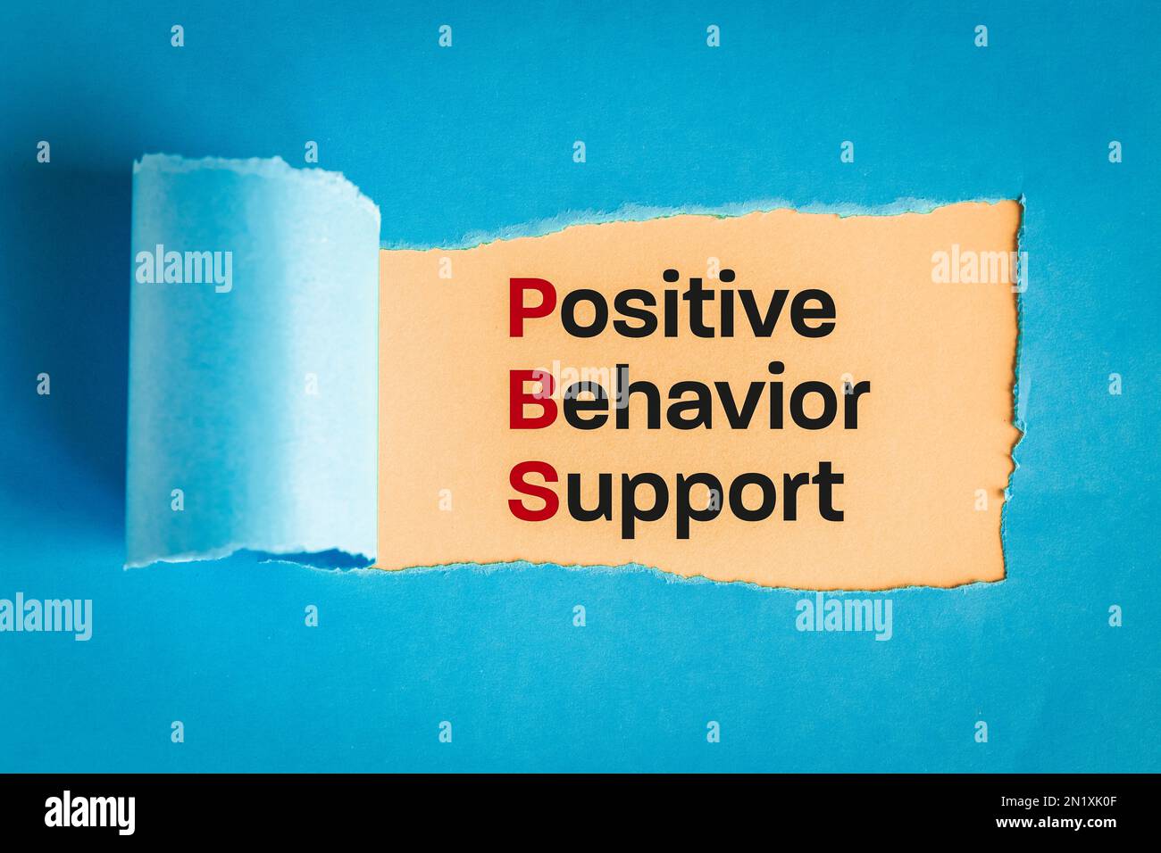 Positive behavior support symbol. text appearing behind torn paper ...