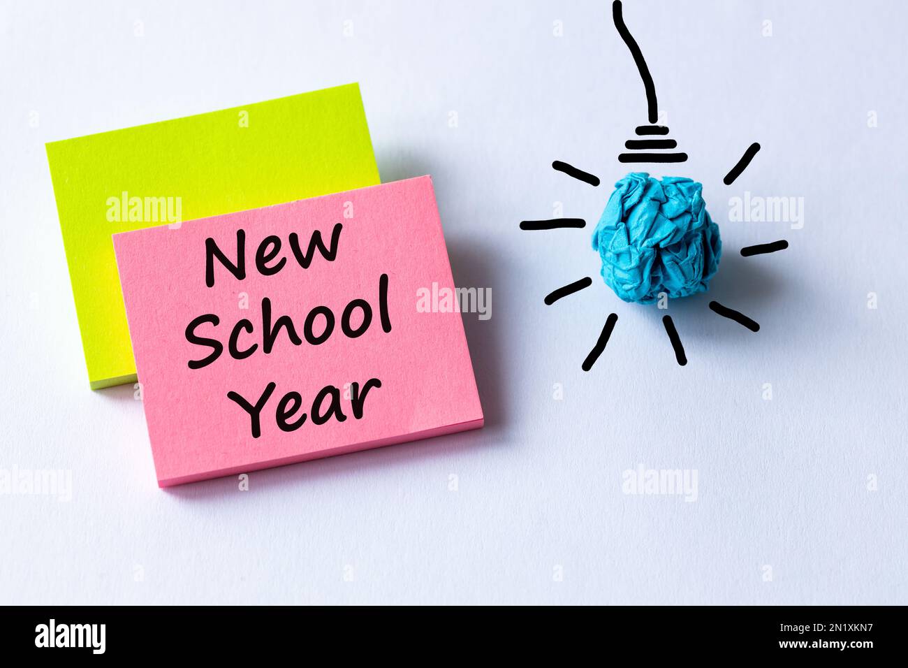 New school year, note on colored sticky notes next to a light bulb icon ...