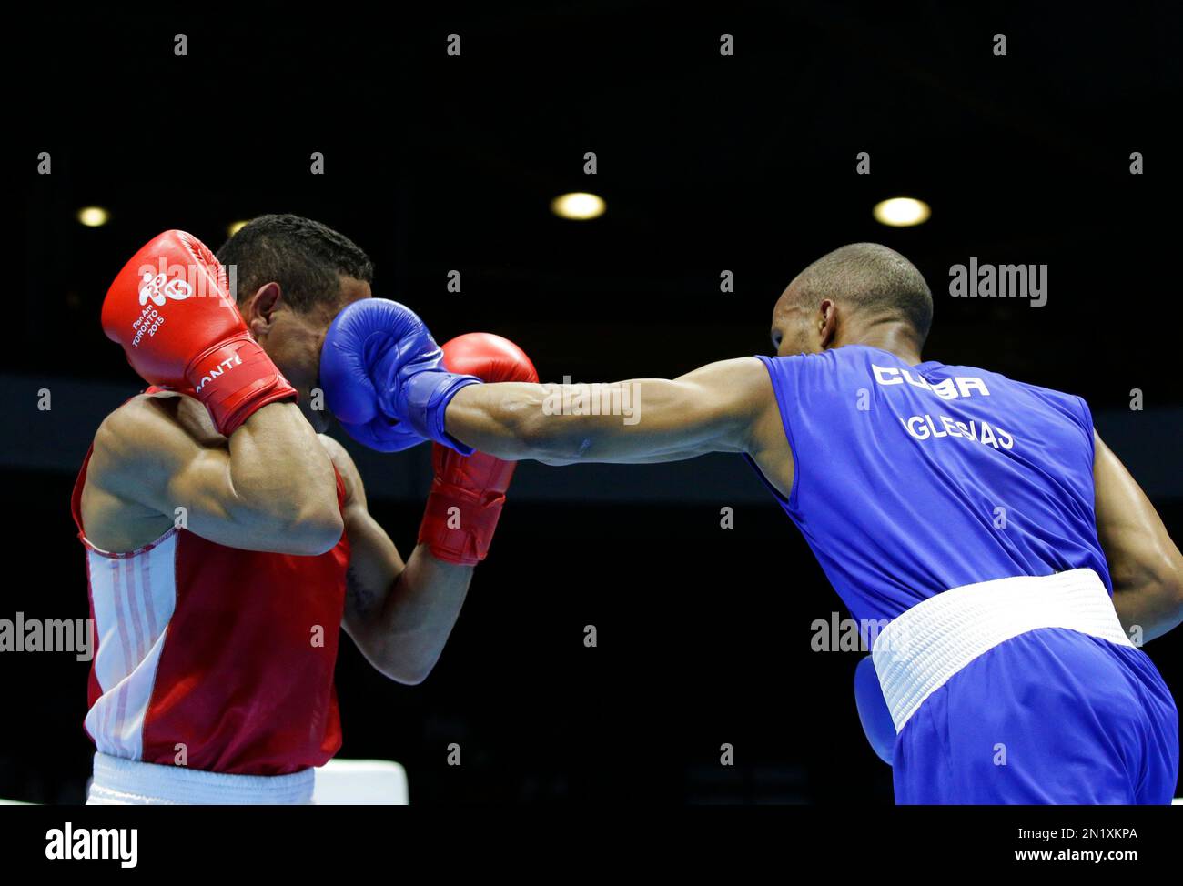 Venezuela’s Gabriel Maestre Perez, left, takes a hit from Cuba’s Roniel ...
