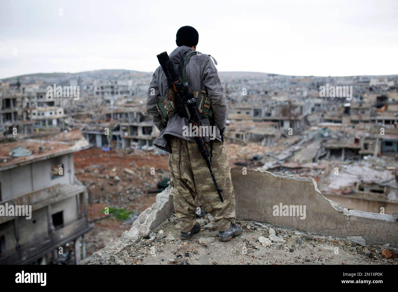 FILE - In this Jan. 30, 2015, file photo, a Syrian Kurdish sniper looks ...